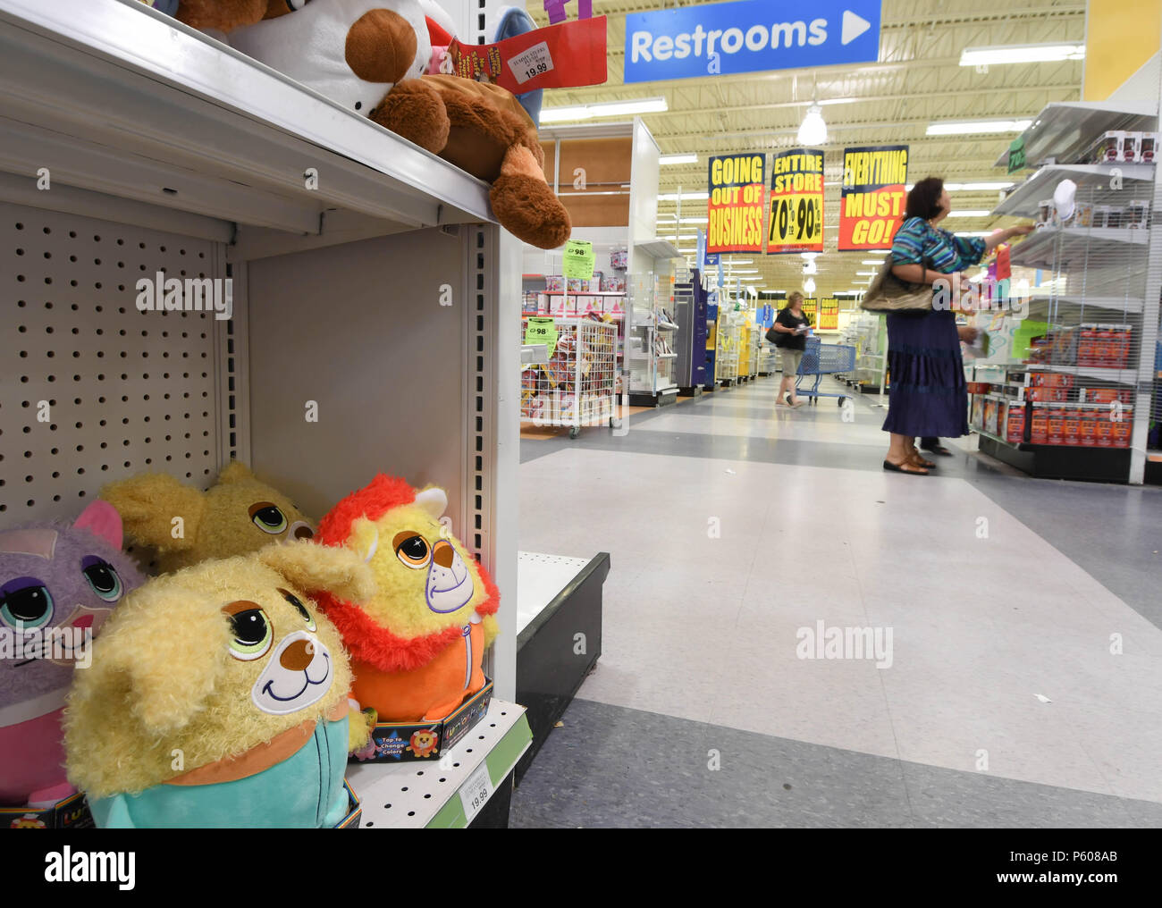 People shop for bargains in a nearly empty Toys R Us store three days ...