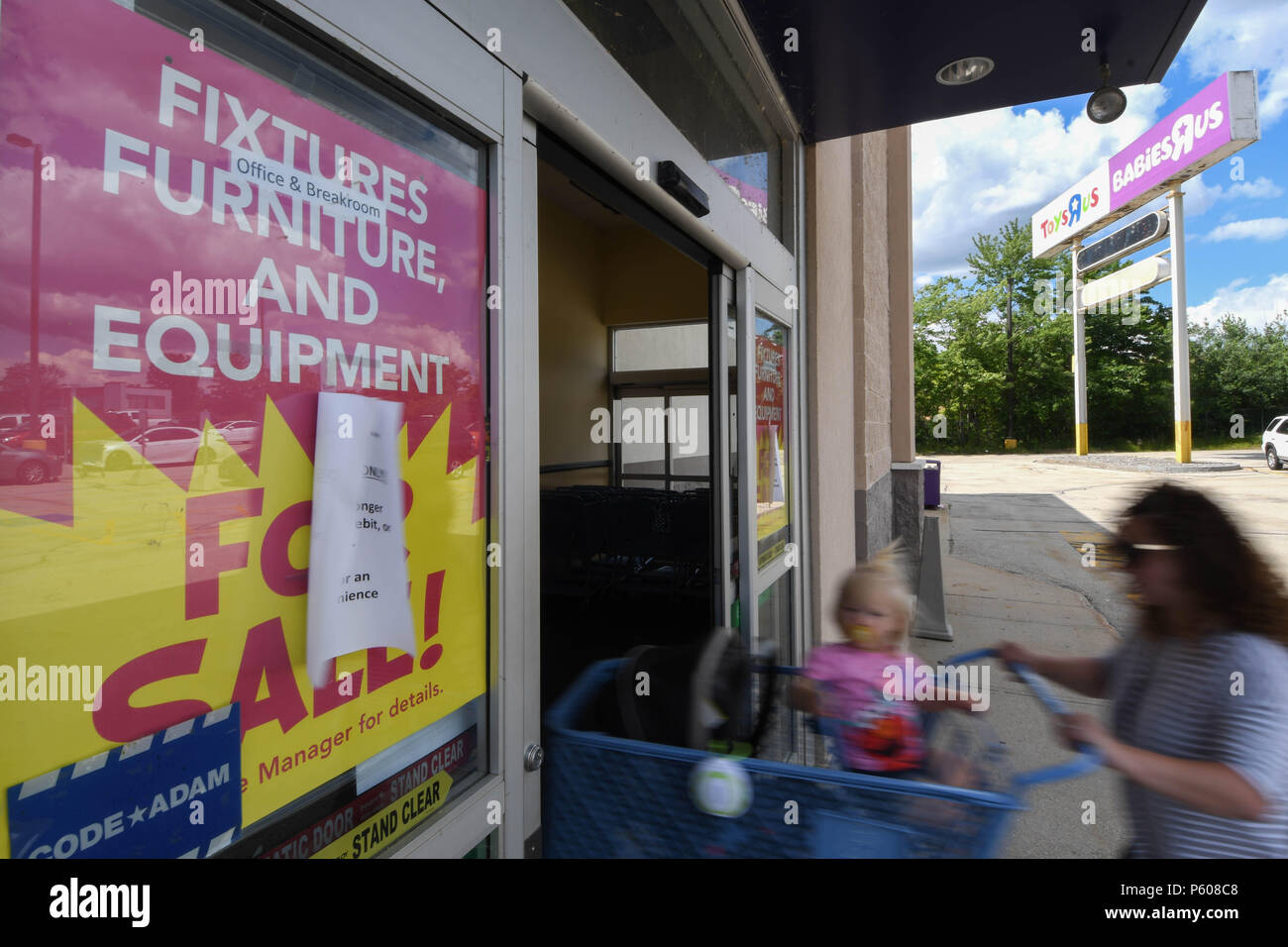 A mother and infant daughter enter the Toys R Us store in Manchester, N ...