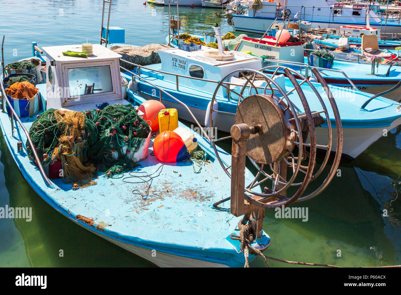 Traditional styled fishing boat with fishing nets and floats, tied up ...