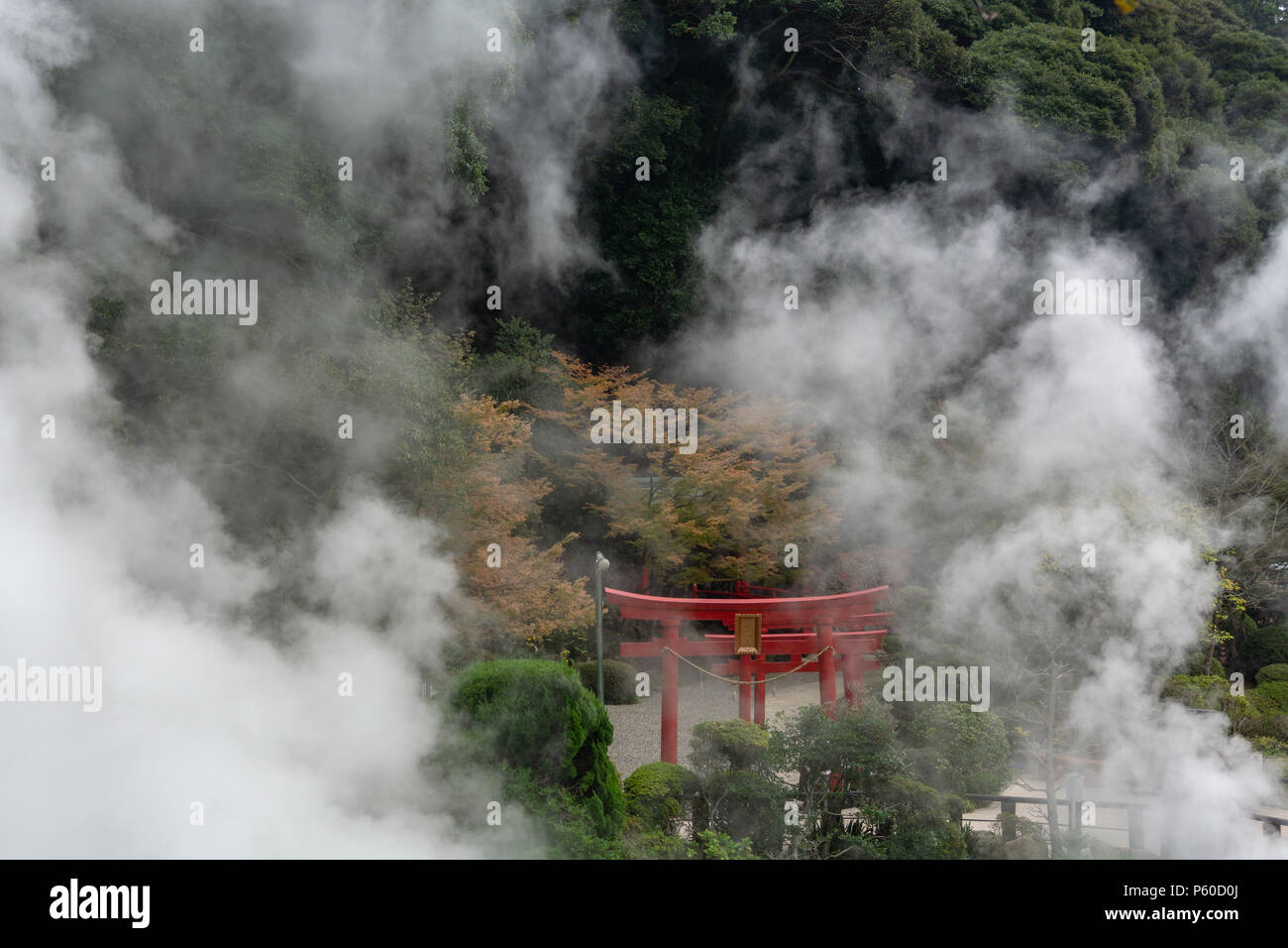 The Japanese red Inari in the midst of steam with Umi Jigoku Pond(Blue ...