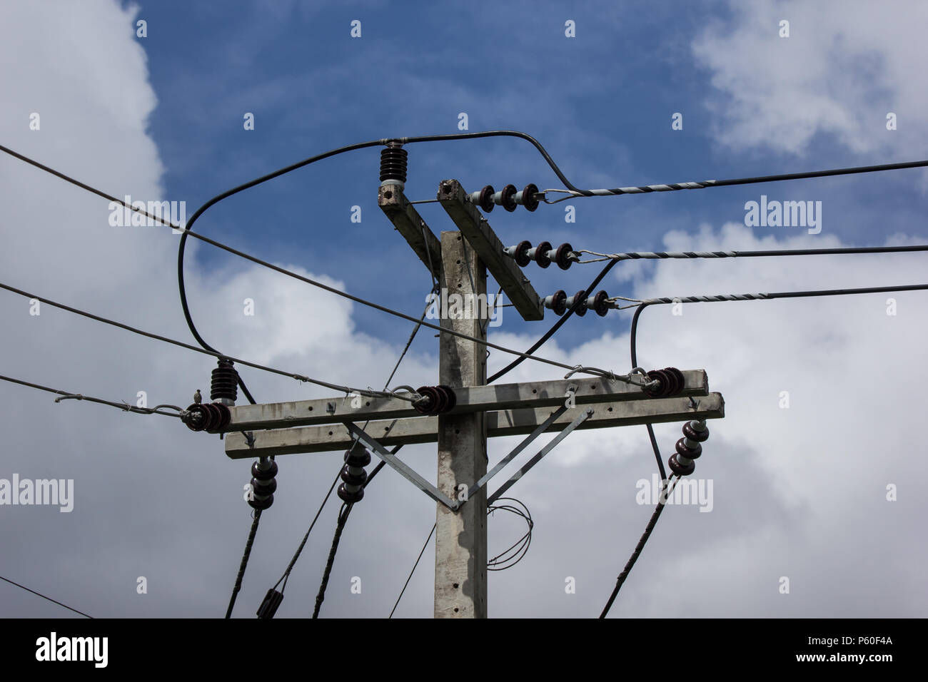 Closeup Eletricity line and electricity post wtih blue sky background ...
