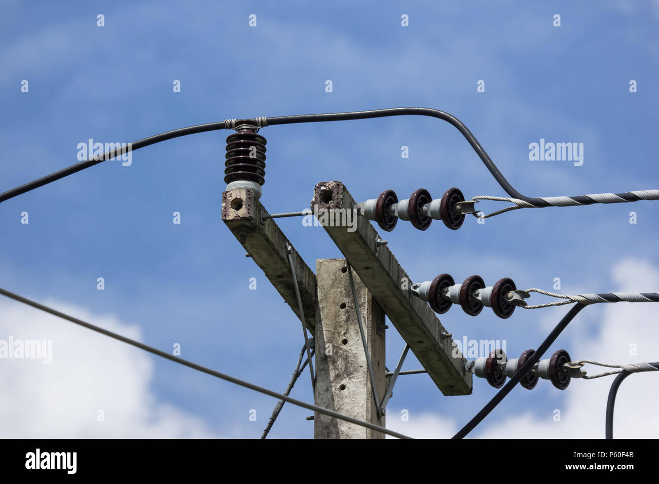 Closeup Eletricity line and electricity post wtih blue sky background ...