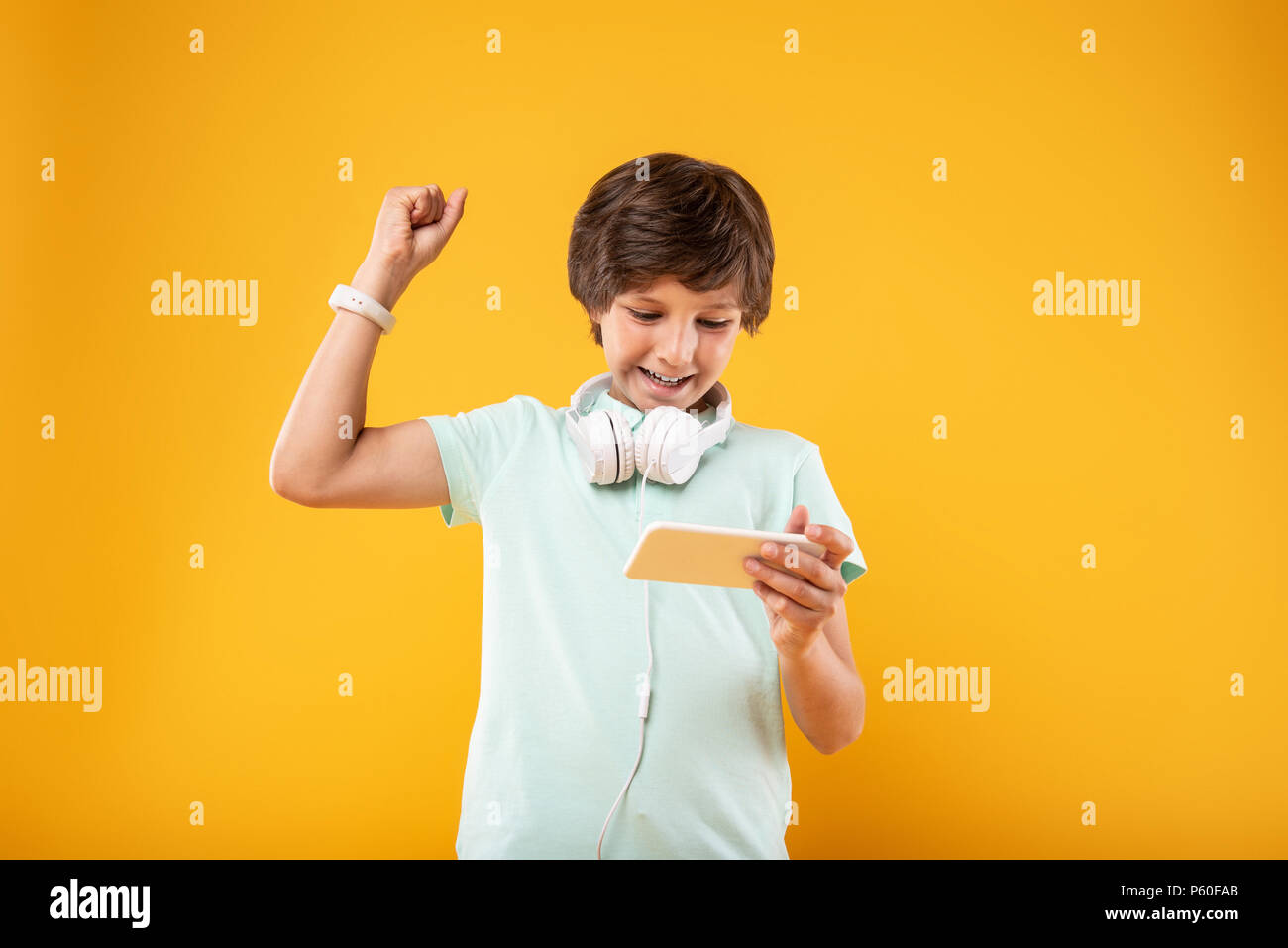 Excited boy using his modern phone Stock Photo - Alamy