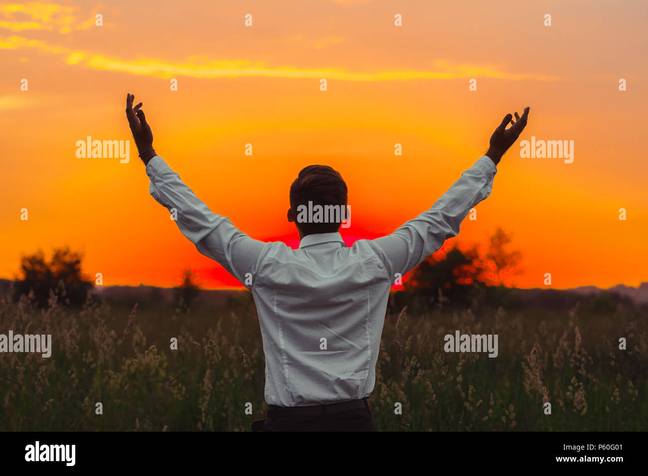 Silhouette of a man with hands raised enjoying his freedom. Concept for ...