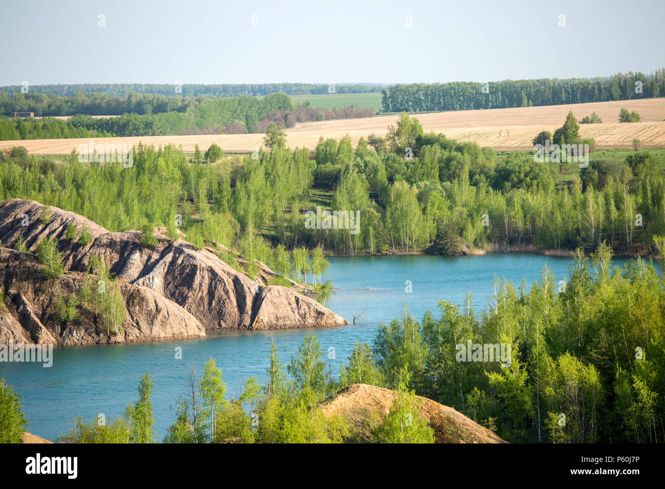 Photo of hilly terrain with green trees and river Stock Photo - Alamy