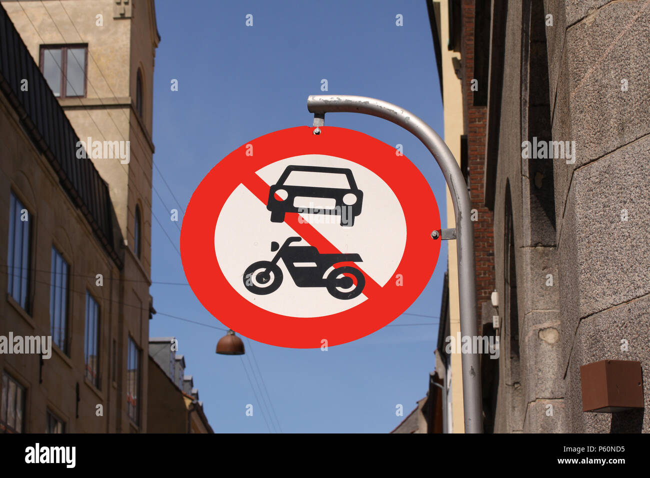 The passage of vehicles and motorcycles is prohibited. Round red and ...