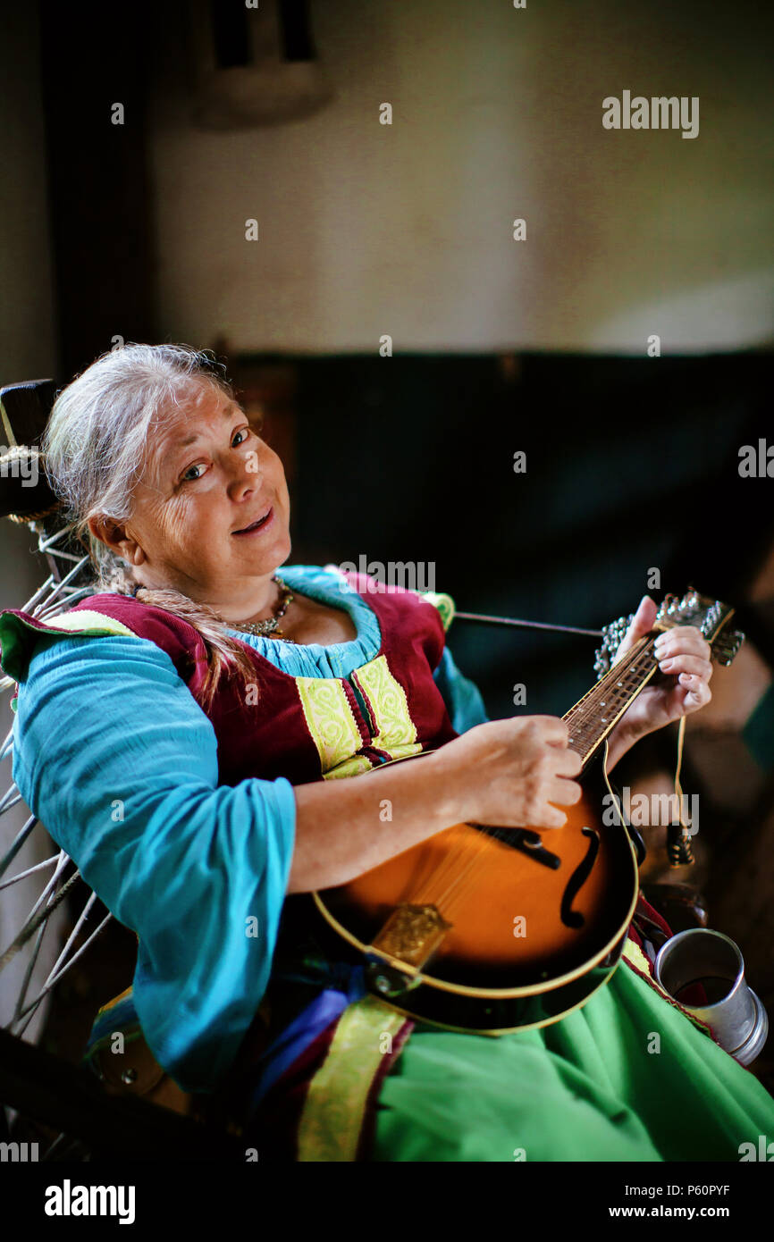 A Renaissance fair actor musician portrays her playful character while ...