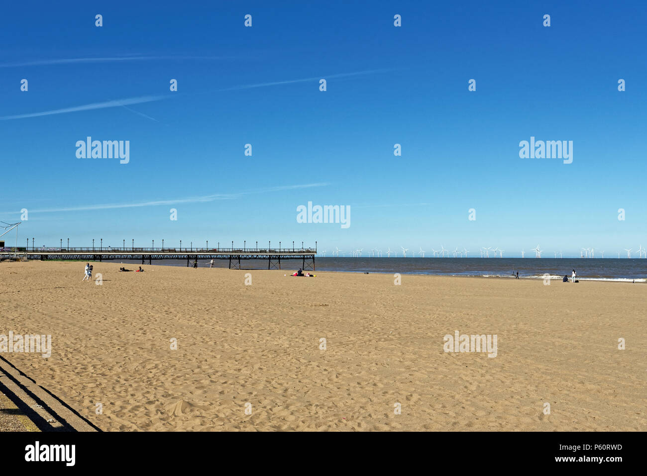 Skegness beach and pier with a wind farm on the horizon Stock Photo - Alamy