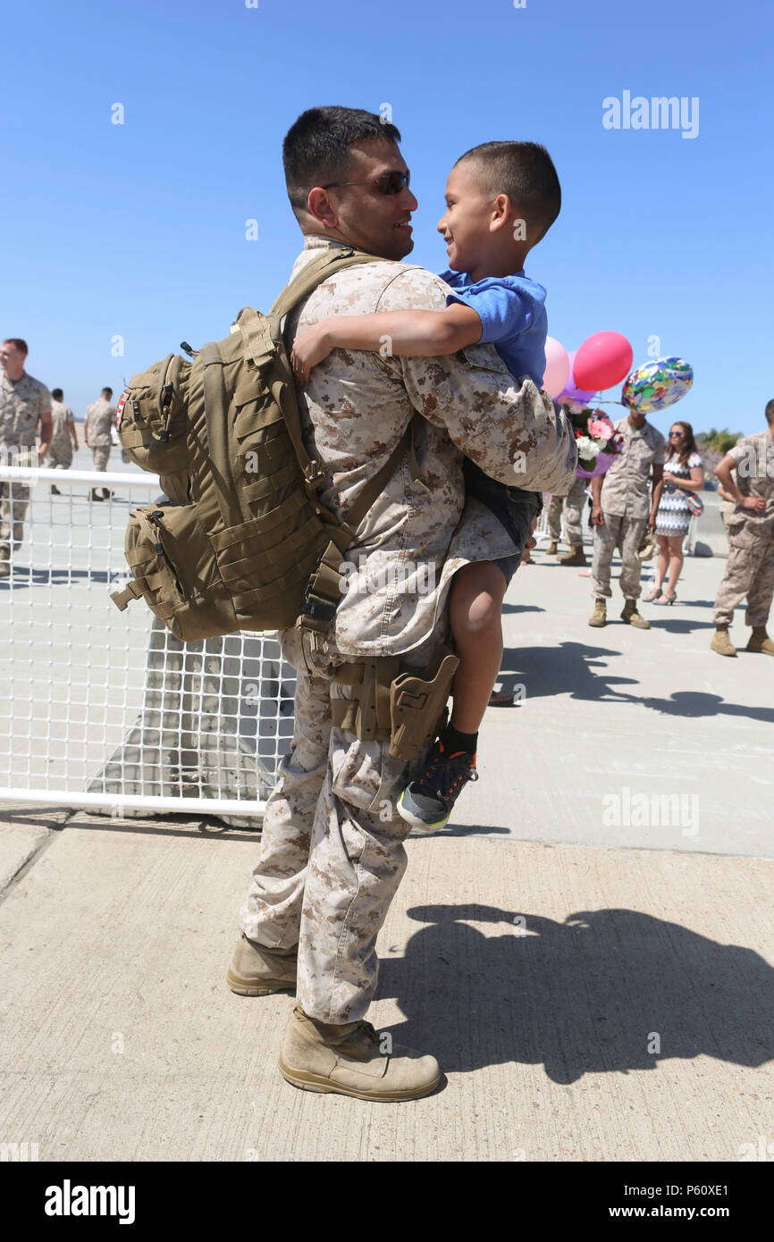 A Marine returning from deployment reunites with his son aboard Marine ...