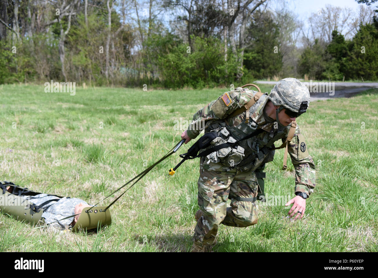 A Soldier competing in the Best Warrior Competition simulates dragging ...