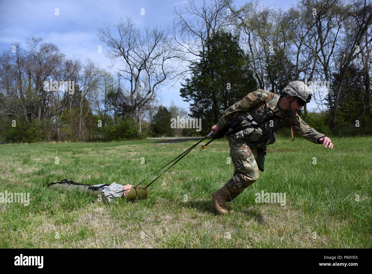 A Soldier competing in the Best Warrior Competition simulates dragging ...