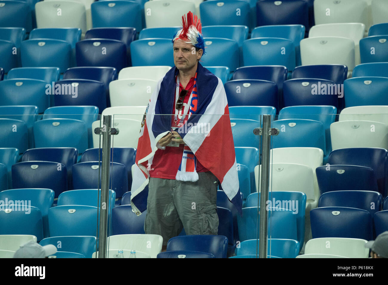 A Costa Rican fan is standing on the tribune, Tribssne, frustrated ...