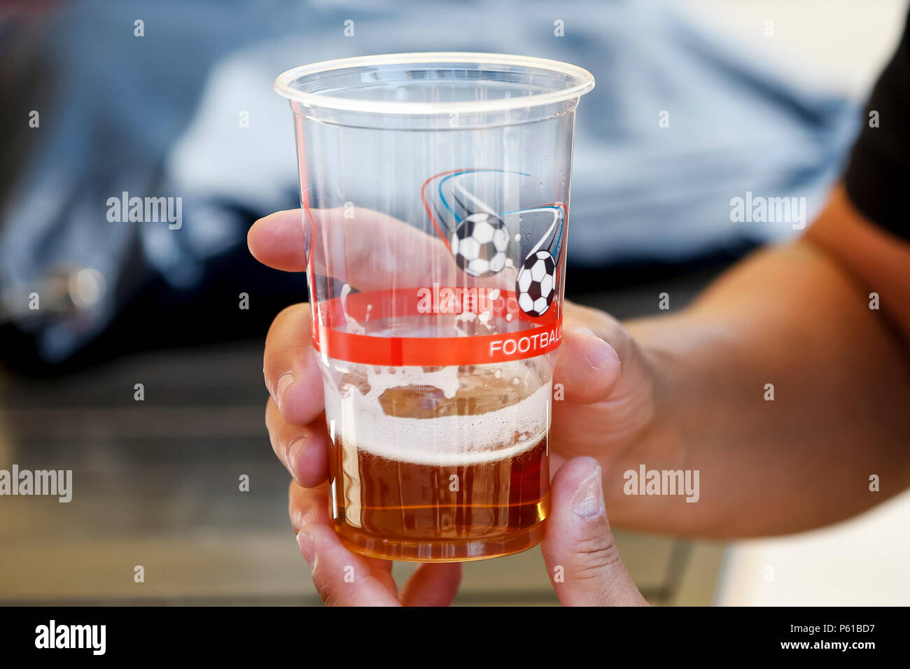 Fans are served in plastic football glasses near the stadium before the ...
