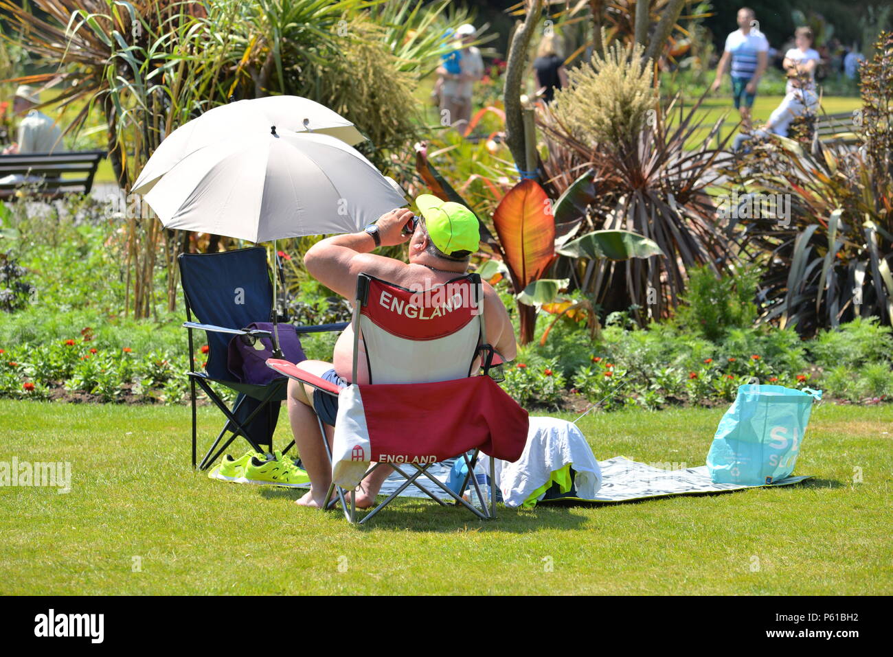 England football fan relaxing in a deckchair drinking beer in the ...