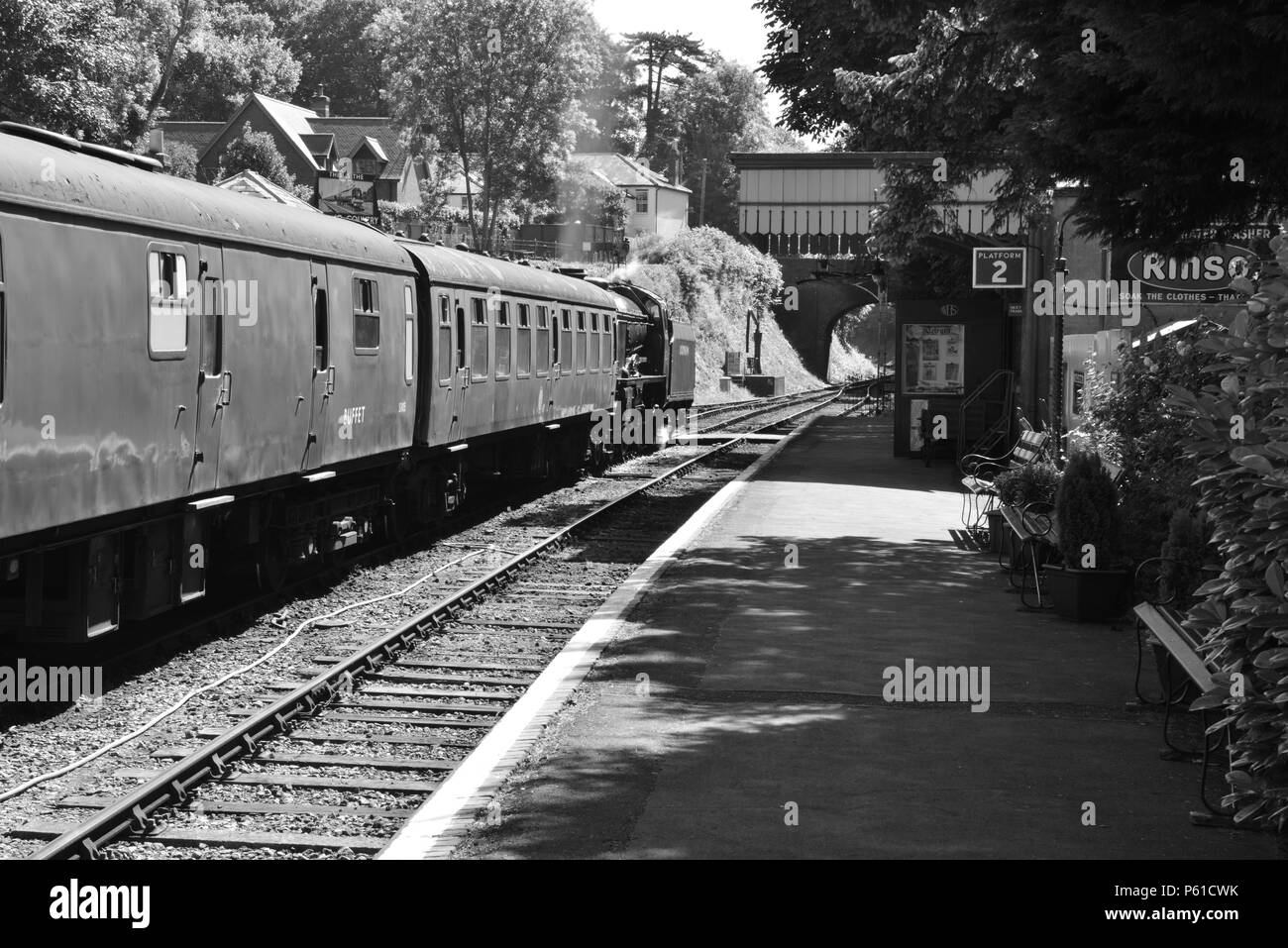 A steam train pulling coaches waiting to depart from a station Stock ...
