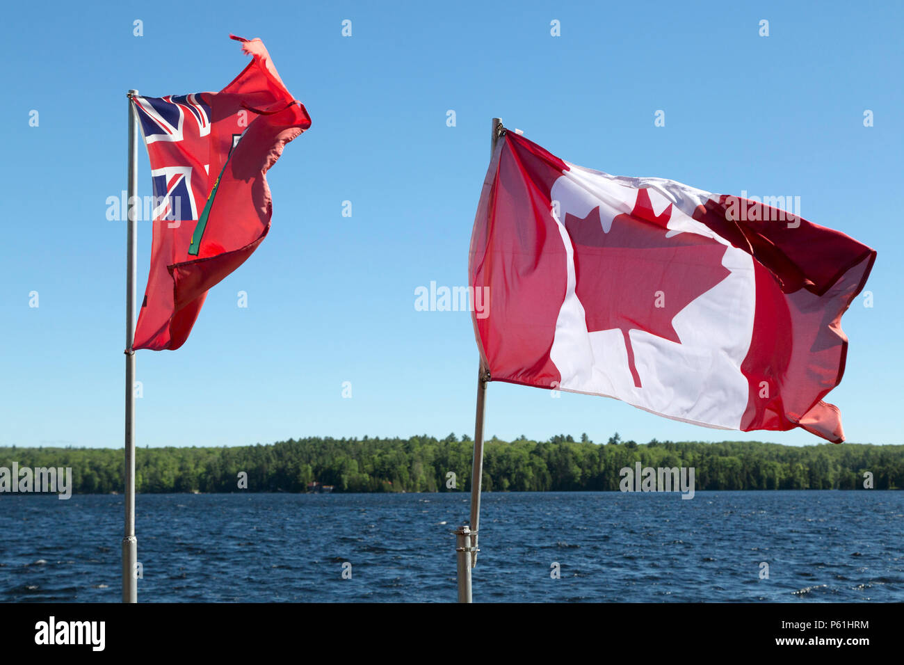 The flags of the province of Ontario and Canada flying by Marble Lake ...