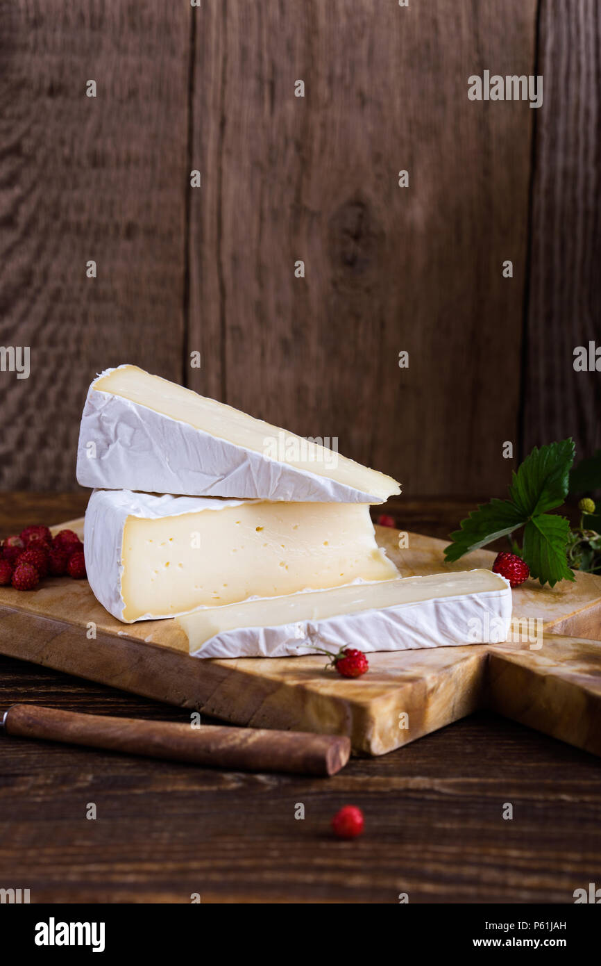 French brie cheese, wild strawberries and white purple wild flower ...