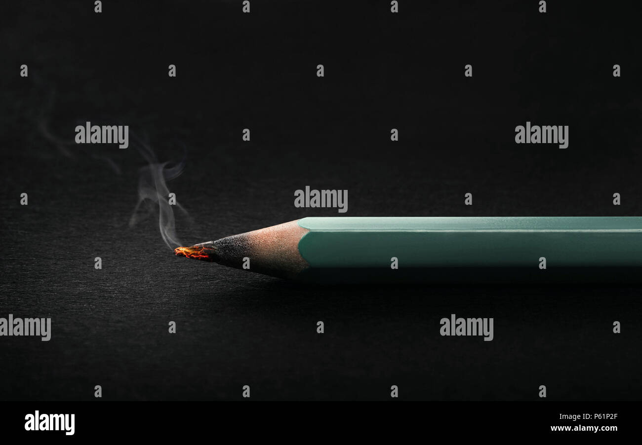 Pencil burning on dark background Stock Photo - Alamy