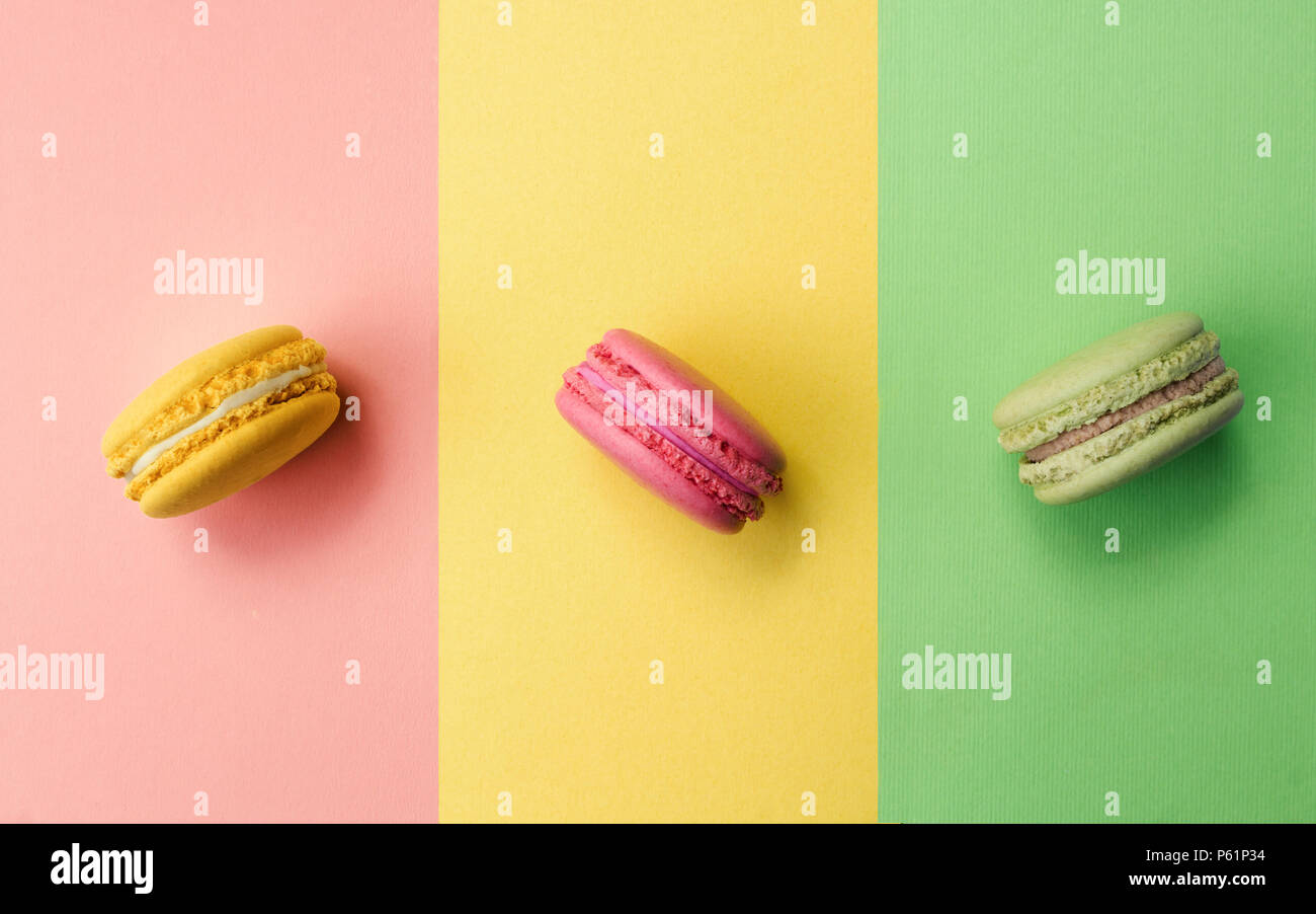 Pink, yellow and green macaroons with same color background Stock Photo ...