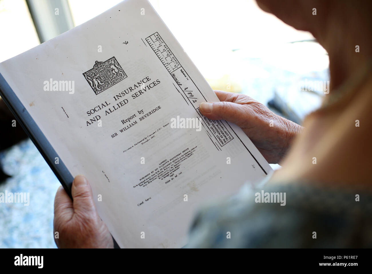 One of the first patients who used the NHS pictured holding a copy of ...