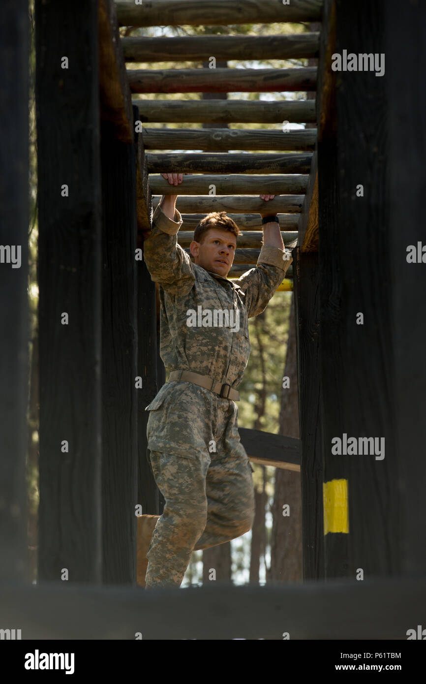 U.S. Army Soldier maneuvers through the Tarzan obstacle, on Darby Queen ...