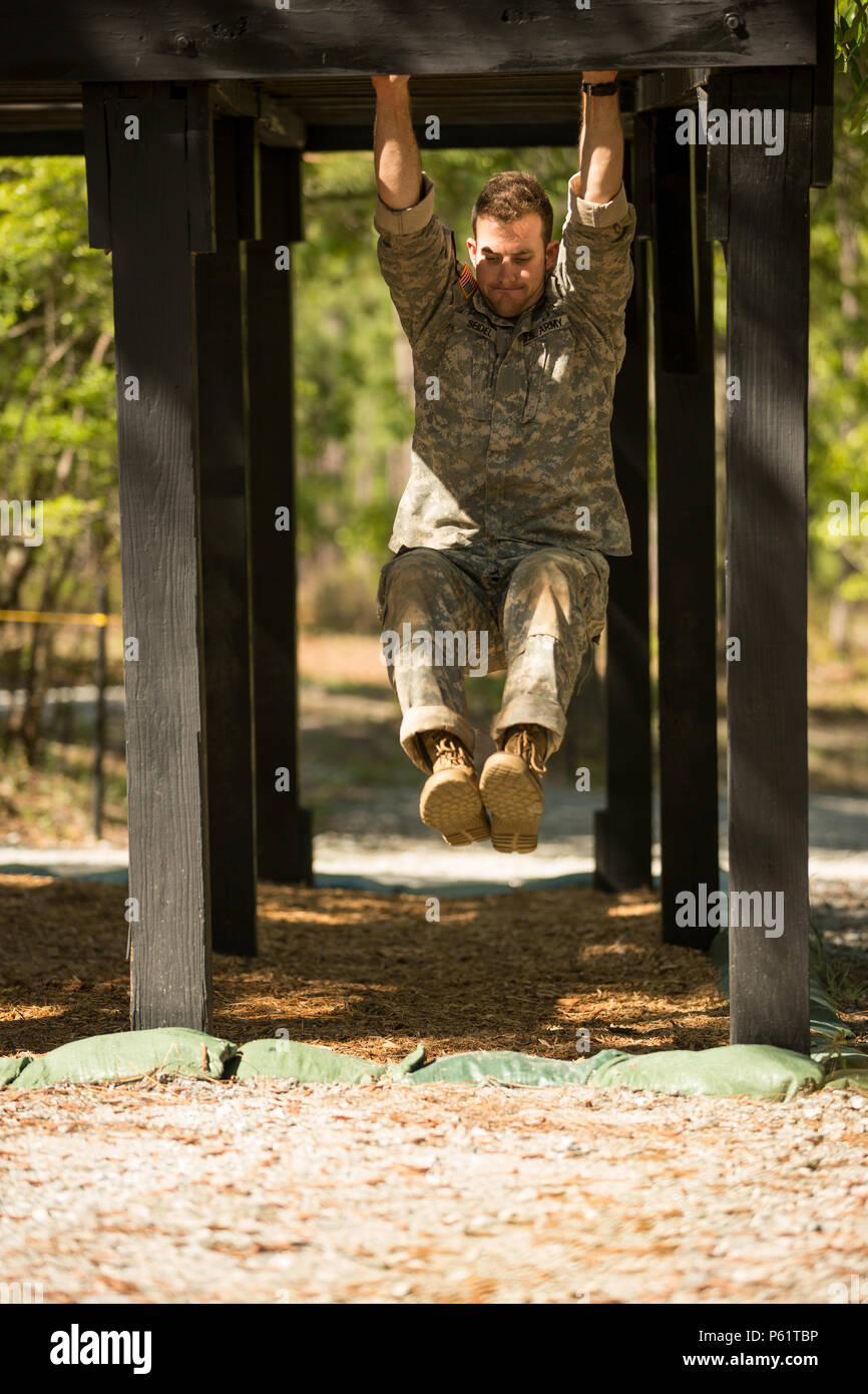 U.S. Army Soldier jumps off of the Horizontal Ladder obstacle, on Darby ...