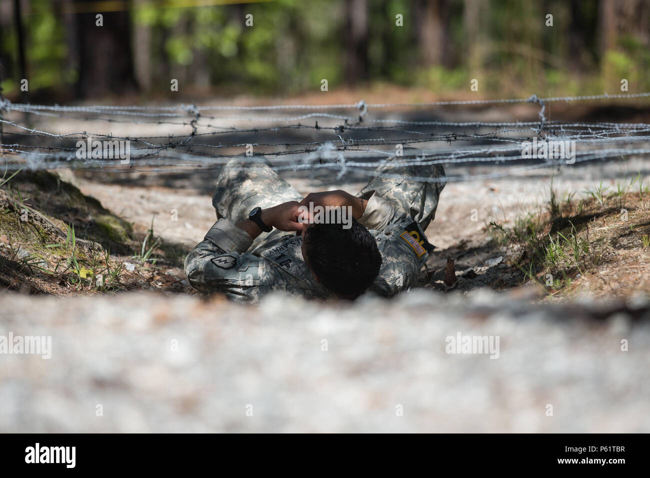 U.S. Army Soldier maneuvers through the Low Wire obstacle,on Darby ...