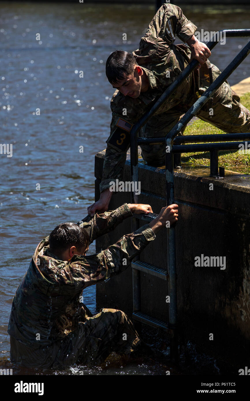 U.S. Army Capt. James Teskey assists his teammate 1st Lt. Nicholas ...