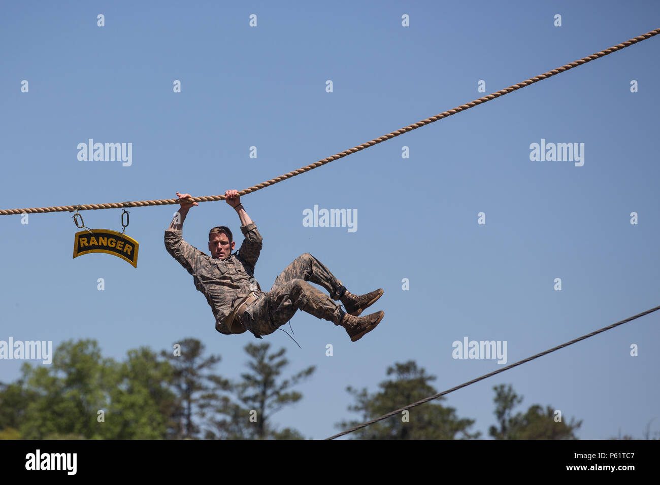 U.S. Army Soldier, climbs across a rope during the Combat Water ...