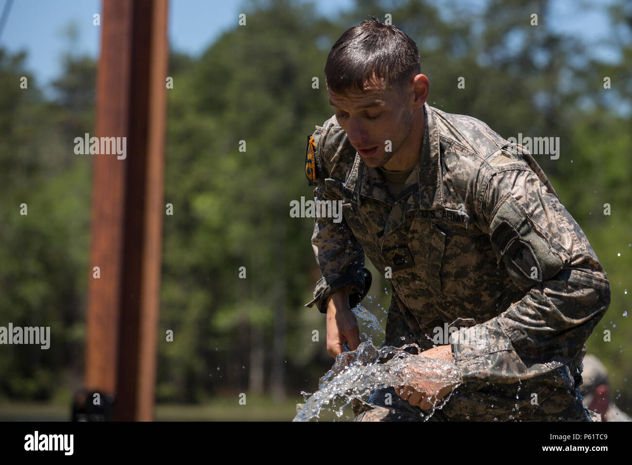 U.S. Army Soldier exits Victory pond after sliding down a zip-line ...