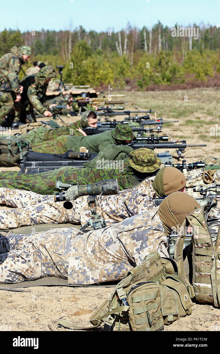 A blend of soldiers from five nations in green, brown and tan uniforms ...