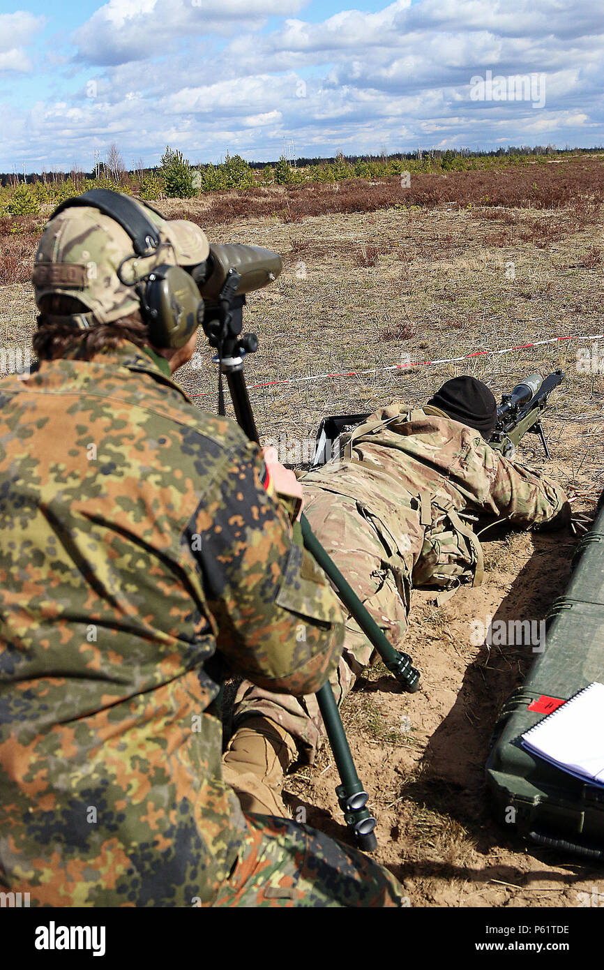 A German soldier coaches a soldier assigned to Headquarters and ...