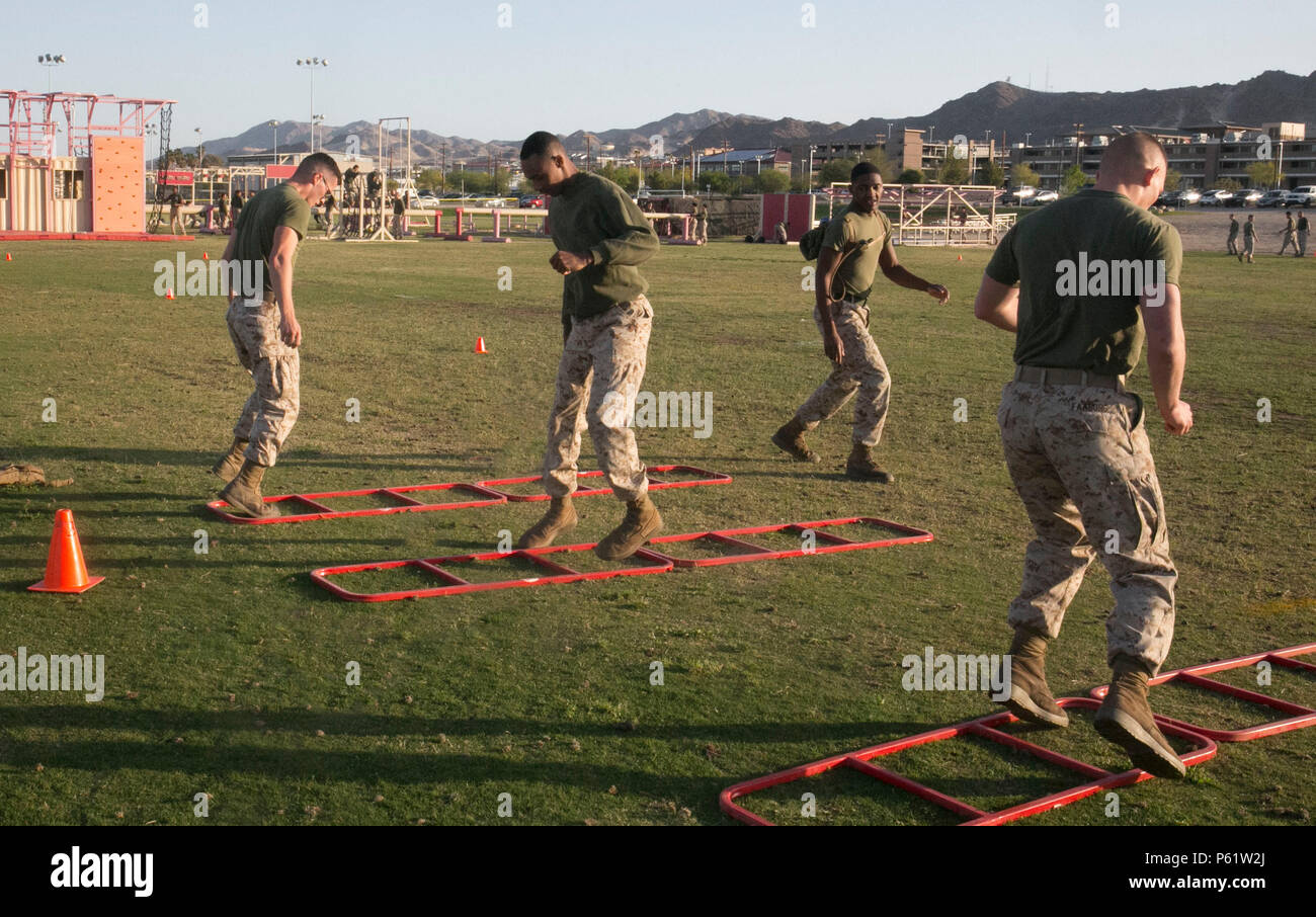 Marines with Headquarters Battalion practice agility drills during a ...