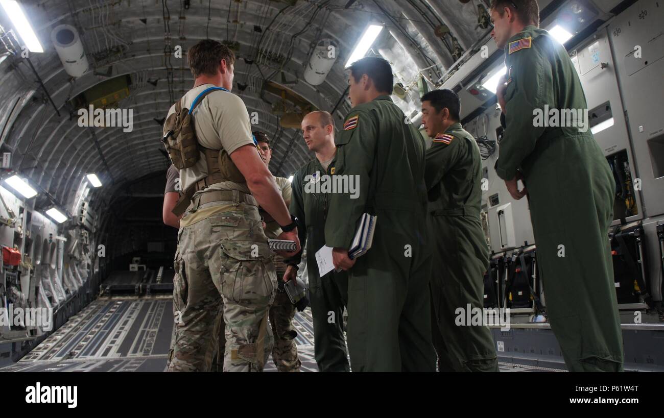 Pararescue jumpers with the 31st Rescue Squadron hold a pre-mission ...