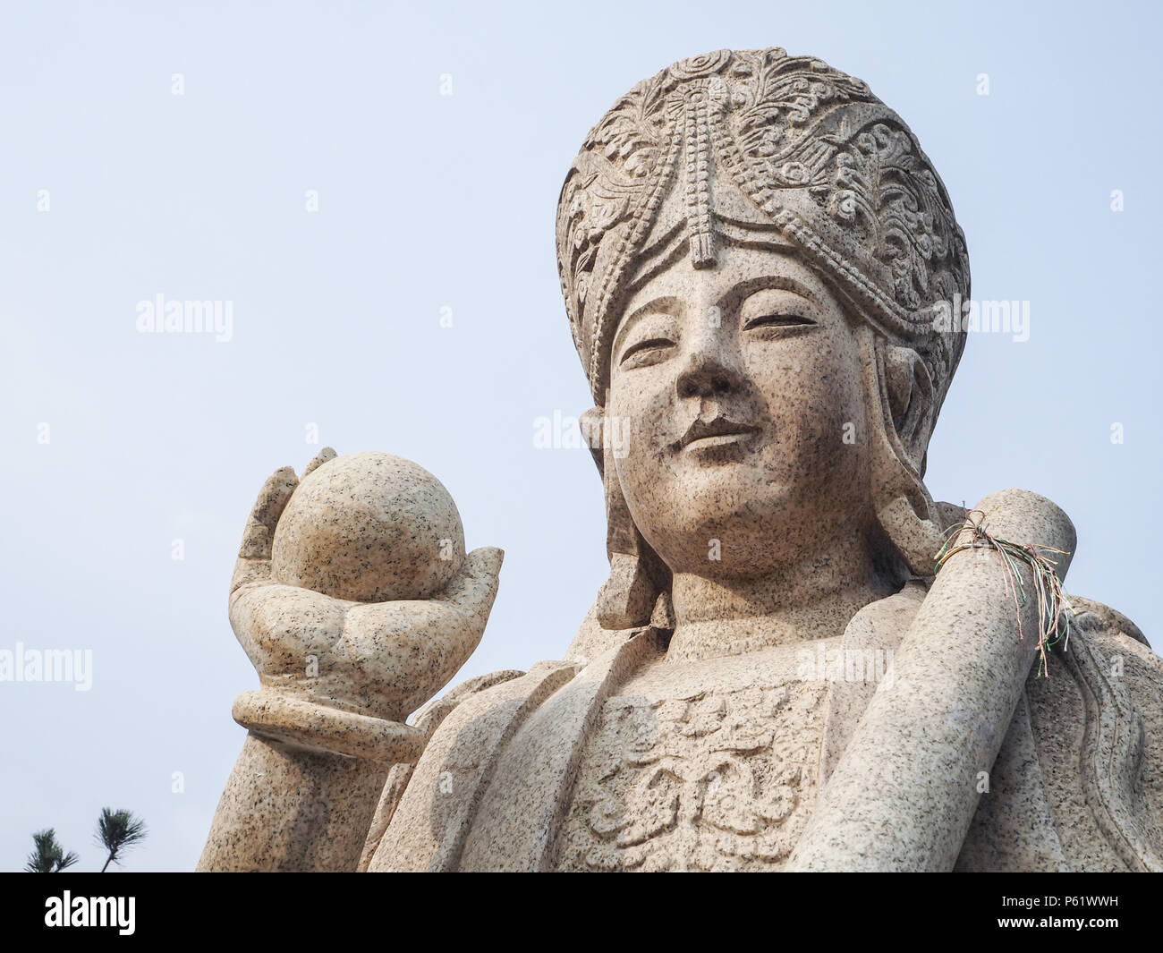 Qingdao, China - December 2017: white carved buddhist sculpture holding ...