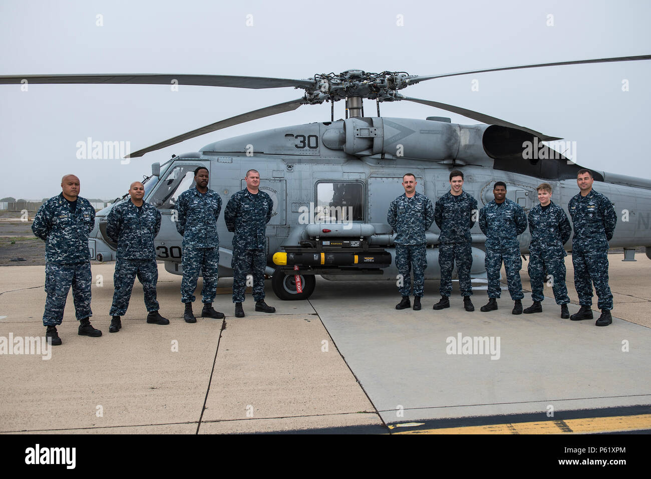 Sailors assigned to Helicopter Maritime Strike Squadron (HSM) 35, stand ...