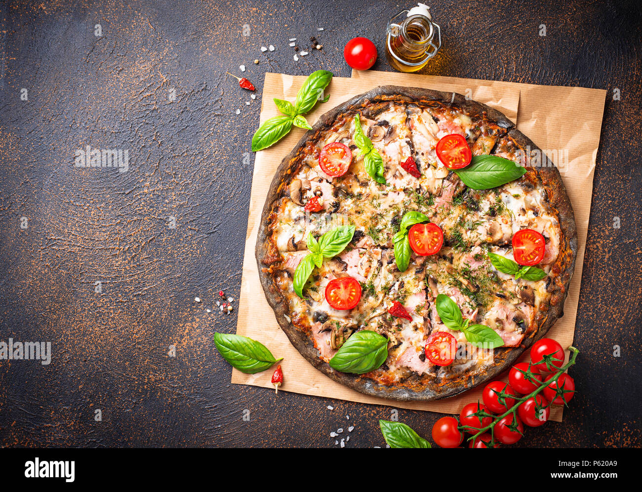 Trendy food Italian black pizza Stock Photo - Alamy