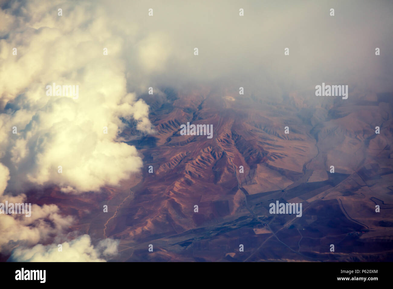 Aerial view through clouds. Airplane view Stock Photo - Alamy
