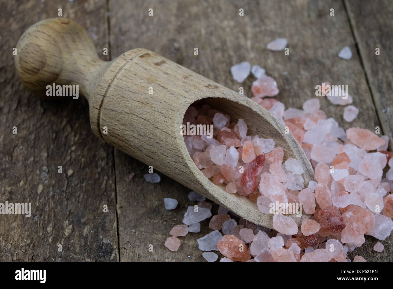 Rock salt and wooden spoon on an old wooden kitchen table. Spices in ...