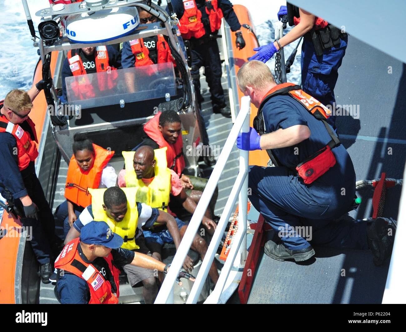 The U.S. Coast Guard Cutter Bernard Webber crew embarks people rescued ...