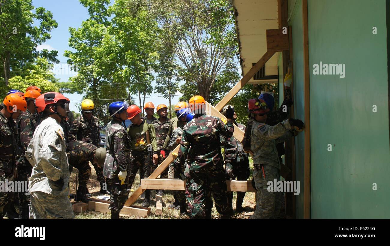 Members of the Armed Forces Philippines place a raker shore against a ...