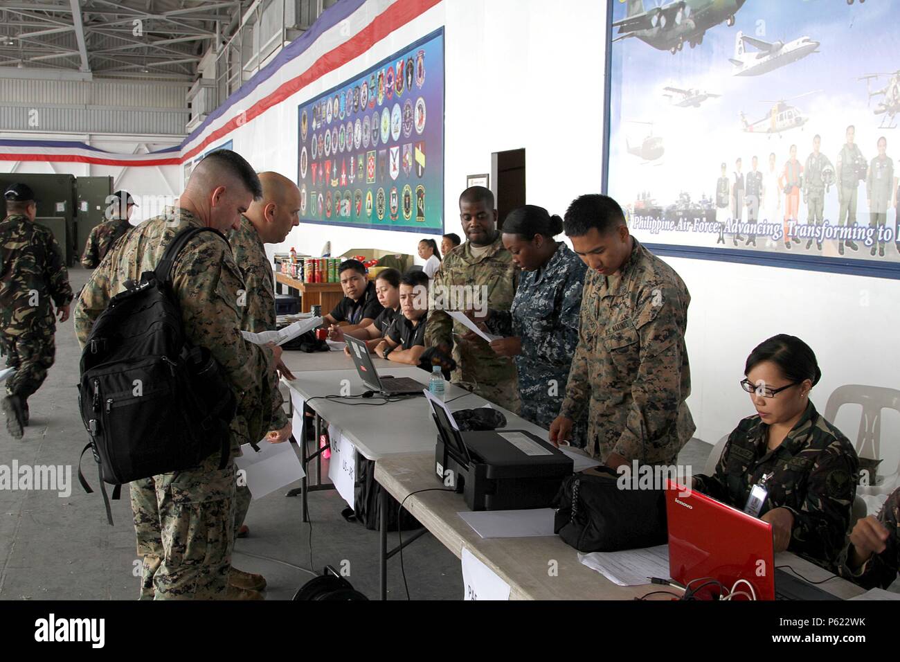 U.S. Marines from the III Marine Expeditionary Force, fall in line to ...