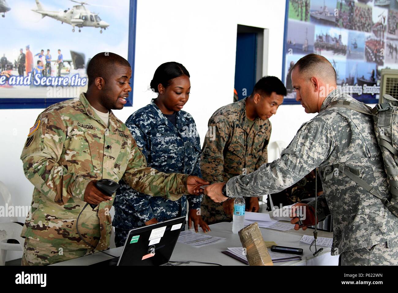 Army Spc. Keith Claudio, Joint Reception Center admin clerk, assigned ...