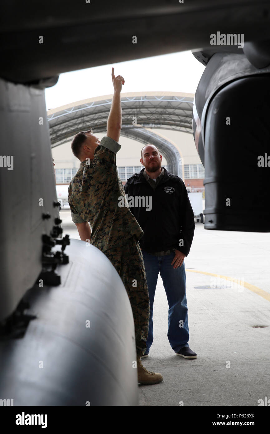 Col. Eric Austin, left, describes the functions of an AV-8B Harrier to ...