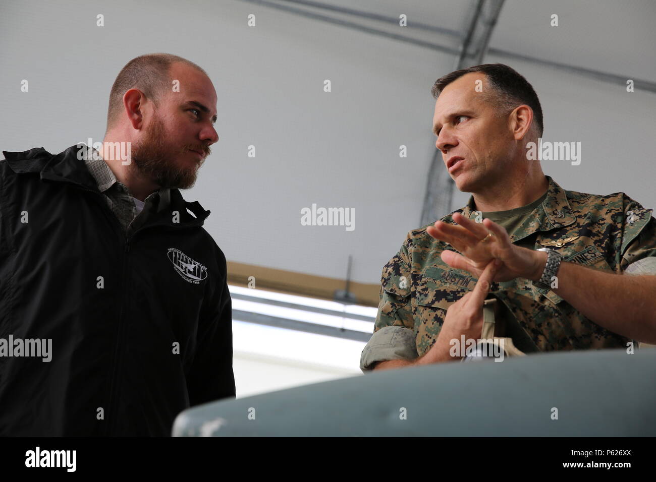 Col. Eric Austin, right, explains the capabilities of the AV-8B Harrier ...