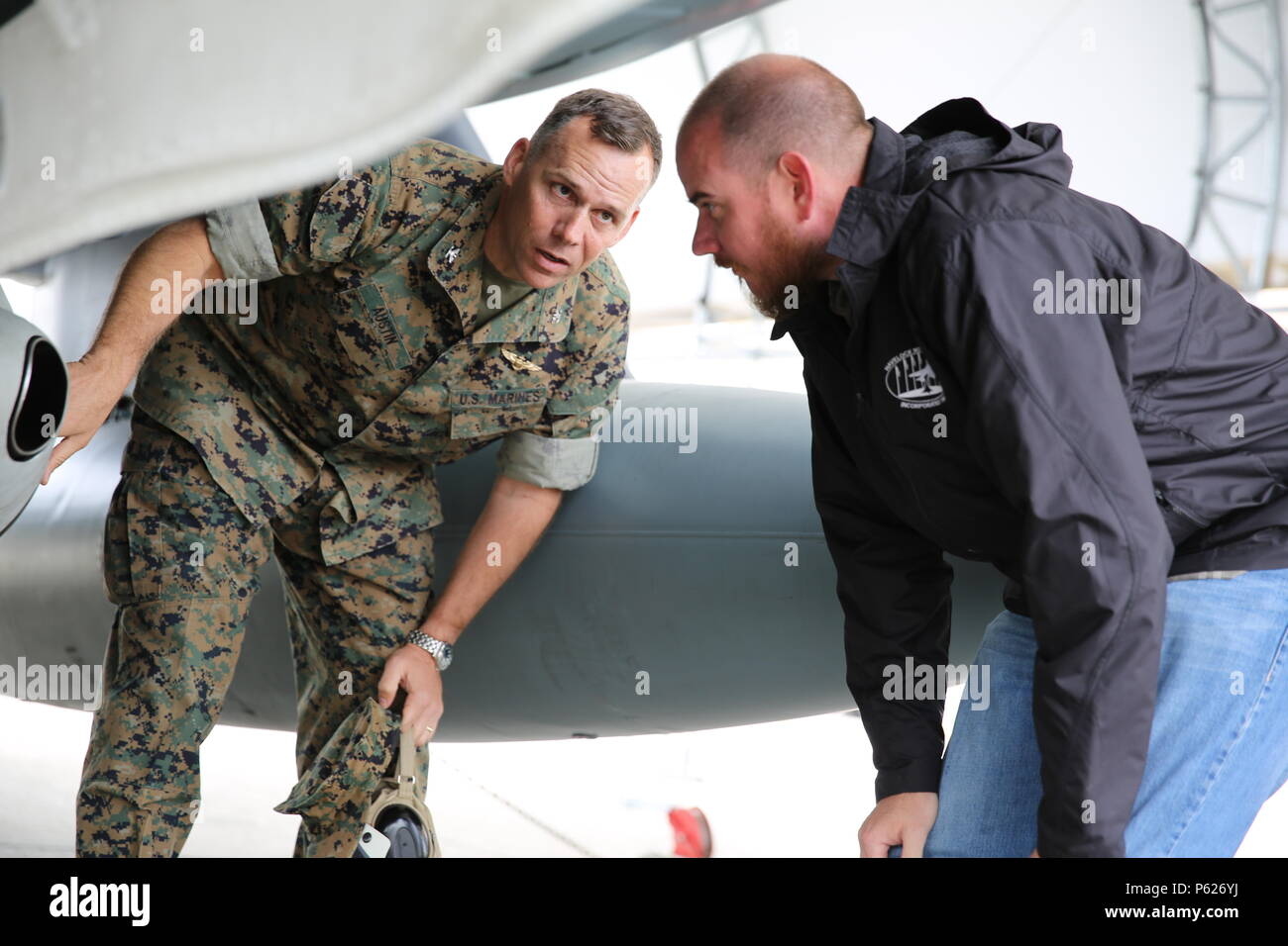 Col. Eric Austin, left, discusses the functions of an AV-8B Harrier ...