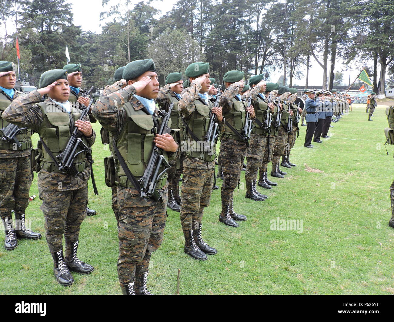 Soldiers from the Guatemalan army mountain division salute the flag ...
