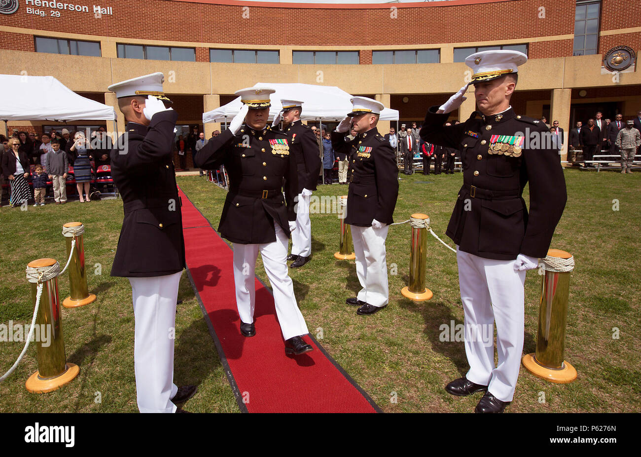 A cadre of his fellow Marine officers serving as side boys render ...