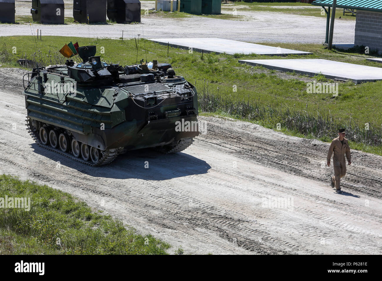 A Marine with Alpha Company, 2nd Assault Amphibian Battalion guides an ...