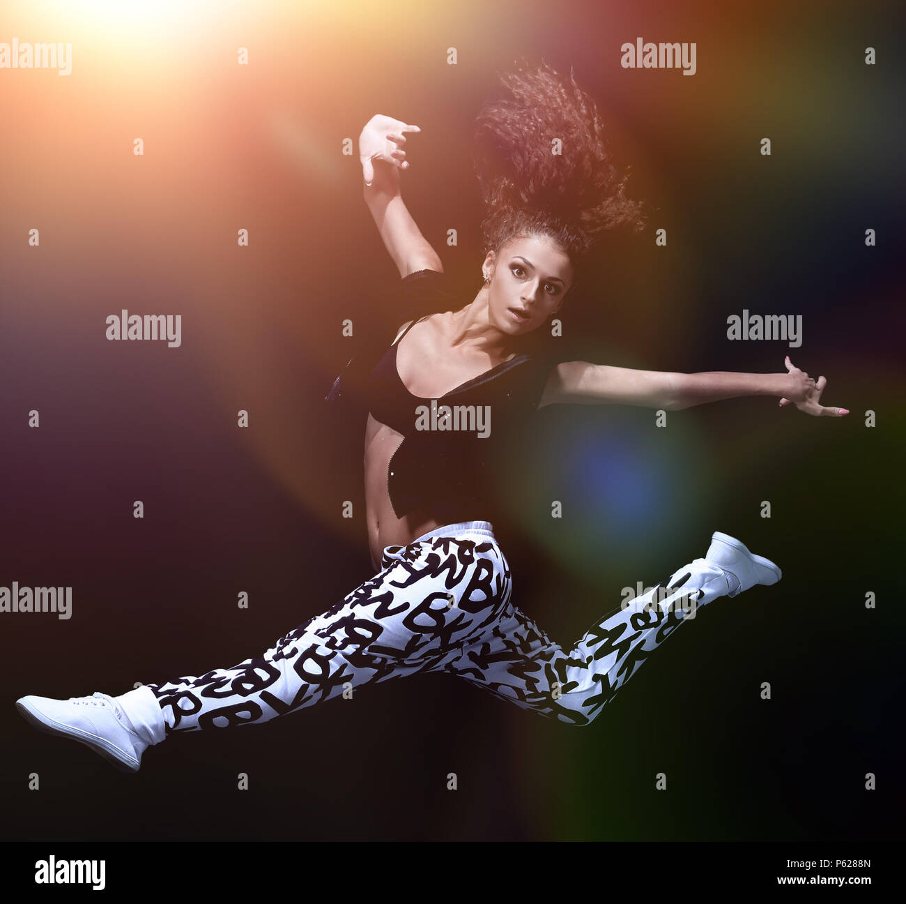 Girl jumping in hip hop style Stock Photo - Alamy